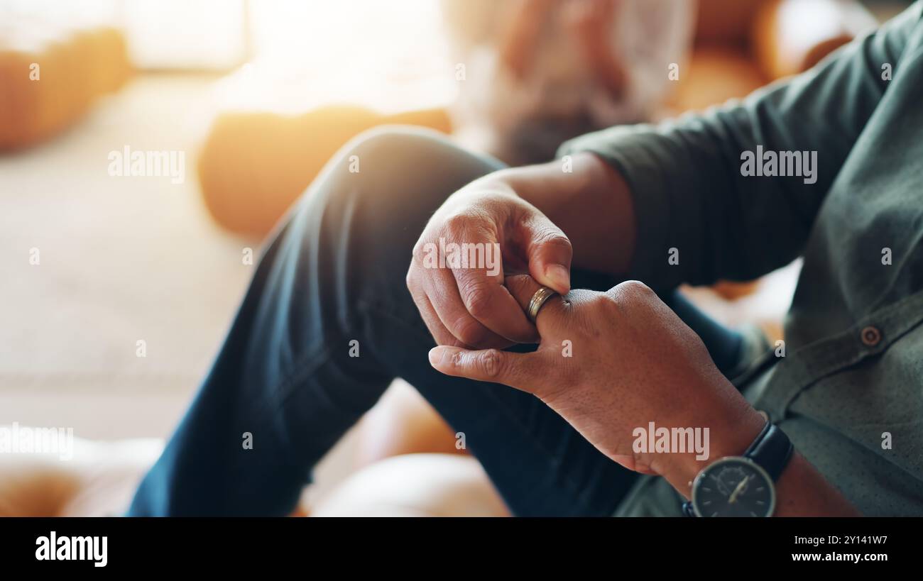 Wedding ring, anxiety and hands of man on sofa for guilt of divorce ...