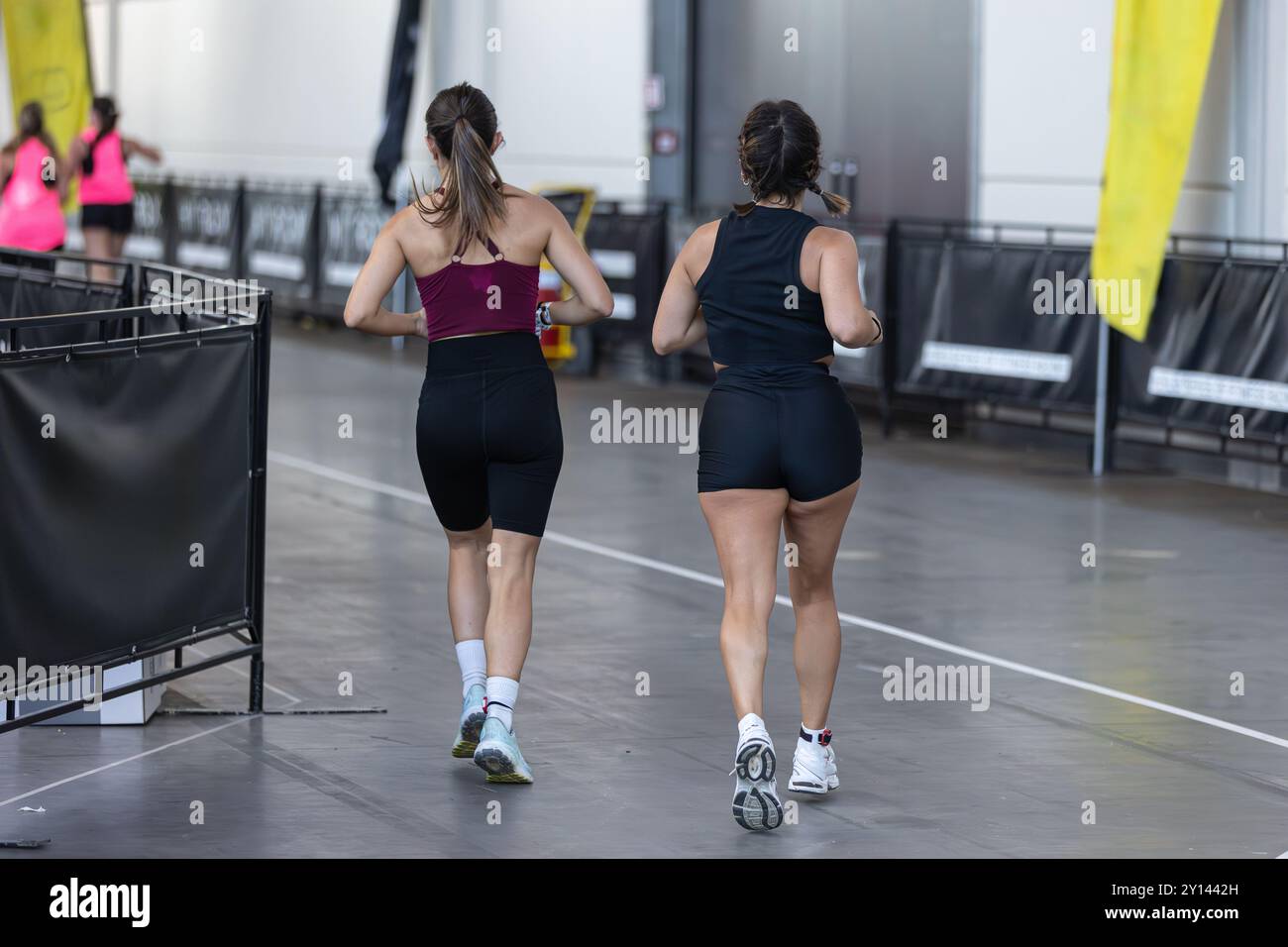 Indoor Marathon - Girls running Together Stock Photo - Alamy