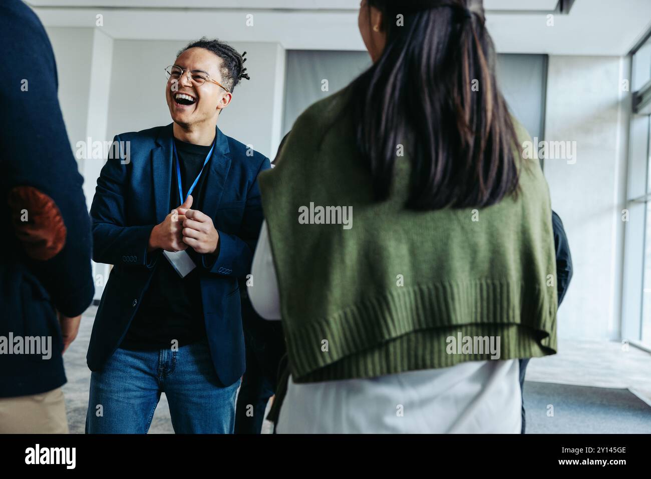 Businessman laughing during a team-building workshop at a workplace ...