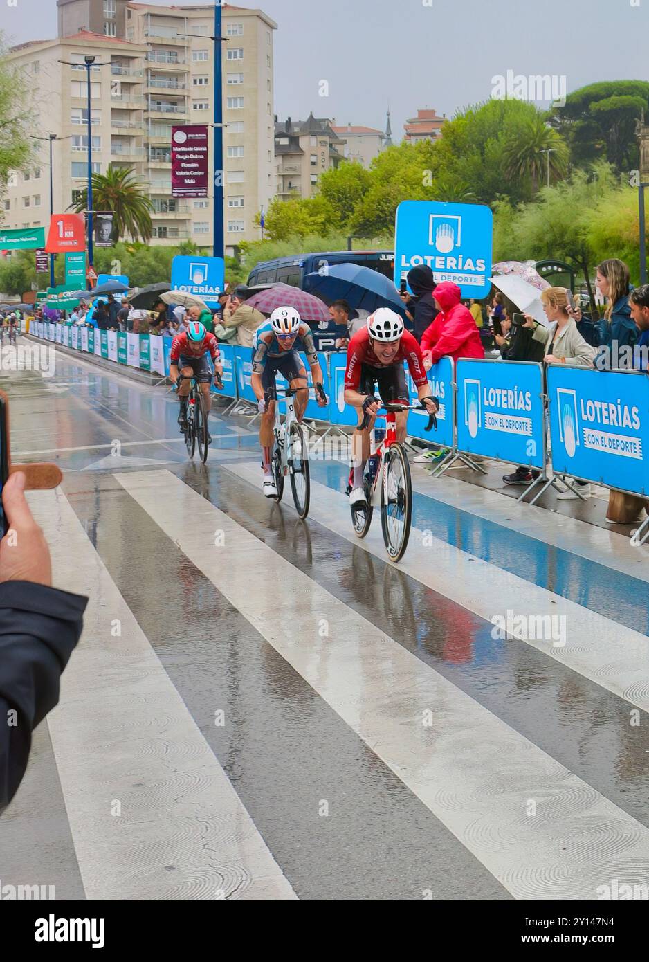 Cyclists competing in the 17th stage of the Vuelta de Espana in pouring ...