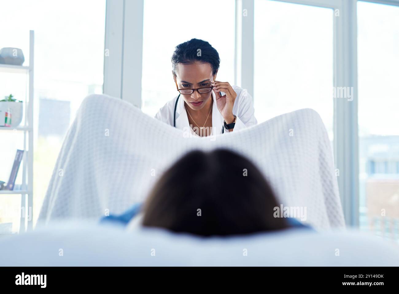 Gynecology, doctor and patient with checkup at clinic for pelvic exam ...
