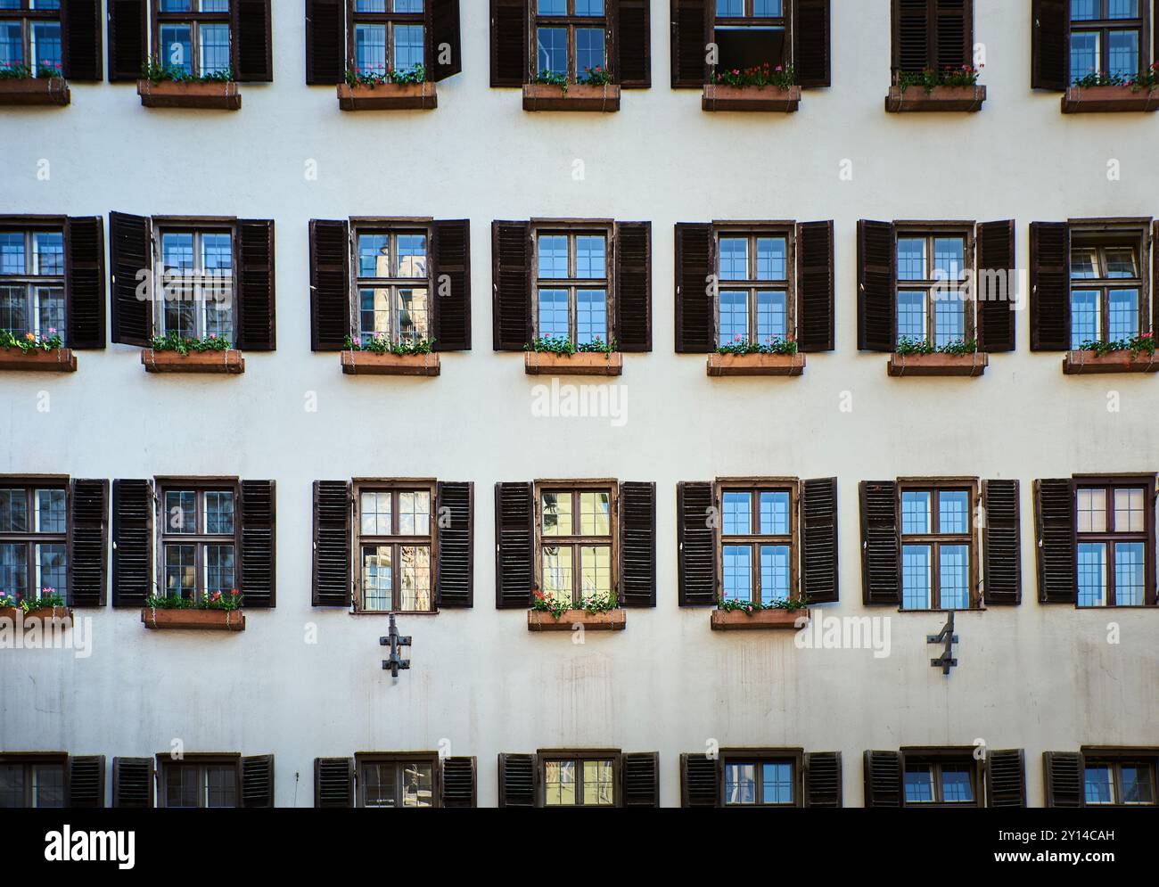 Old building facade with pattern of open old windows with wooden ...