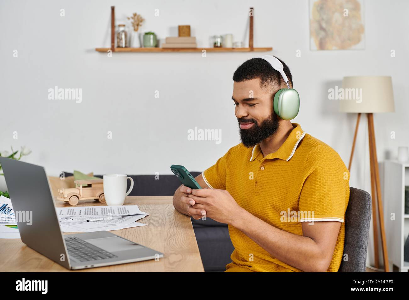 Relaxed man connects with technology while enjoying his cozy home ...