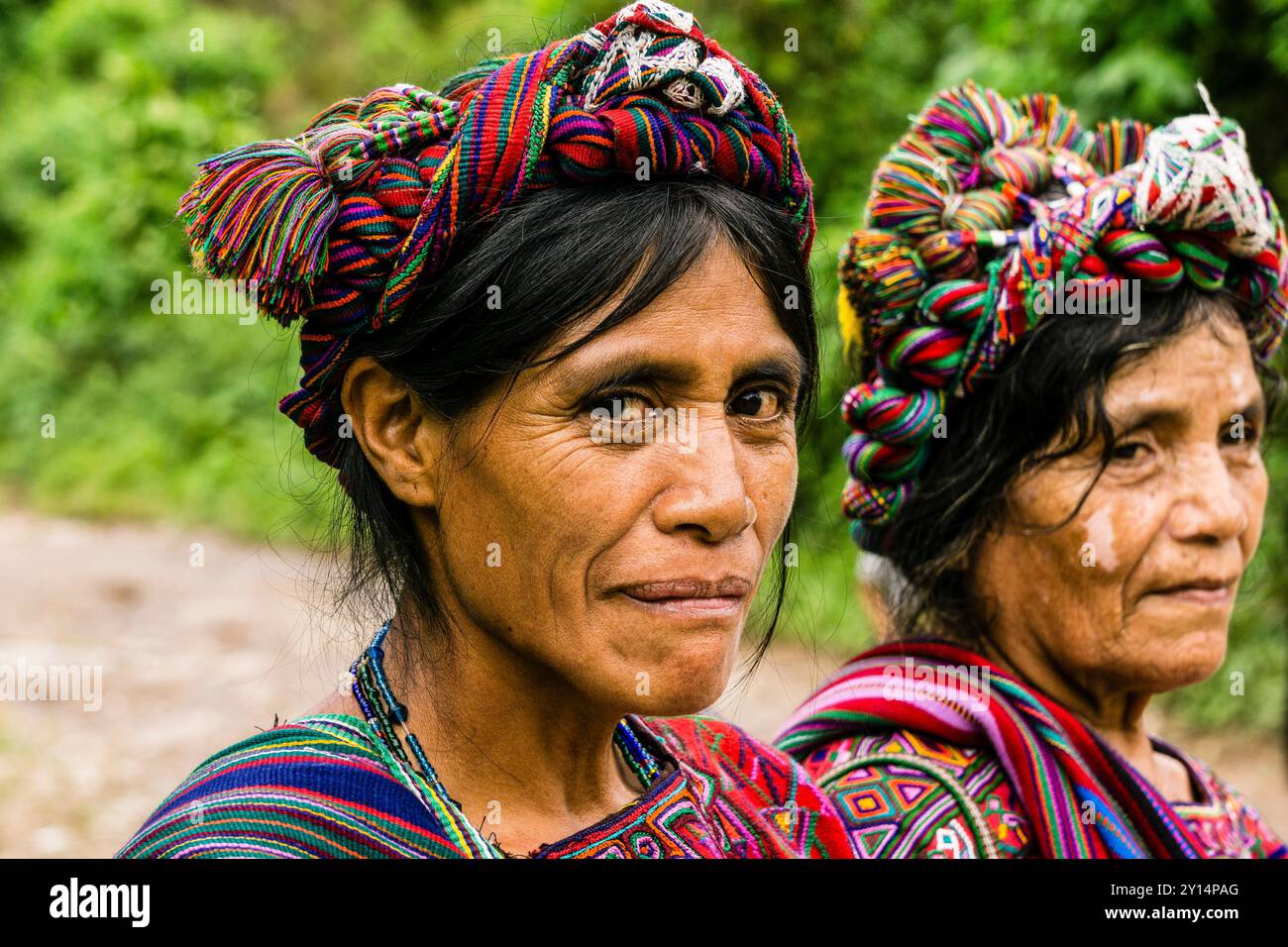 Women in indigenous costume and Queqchi headdress, on the road from La ...