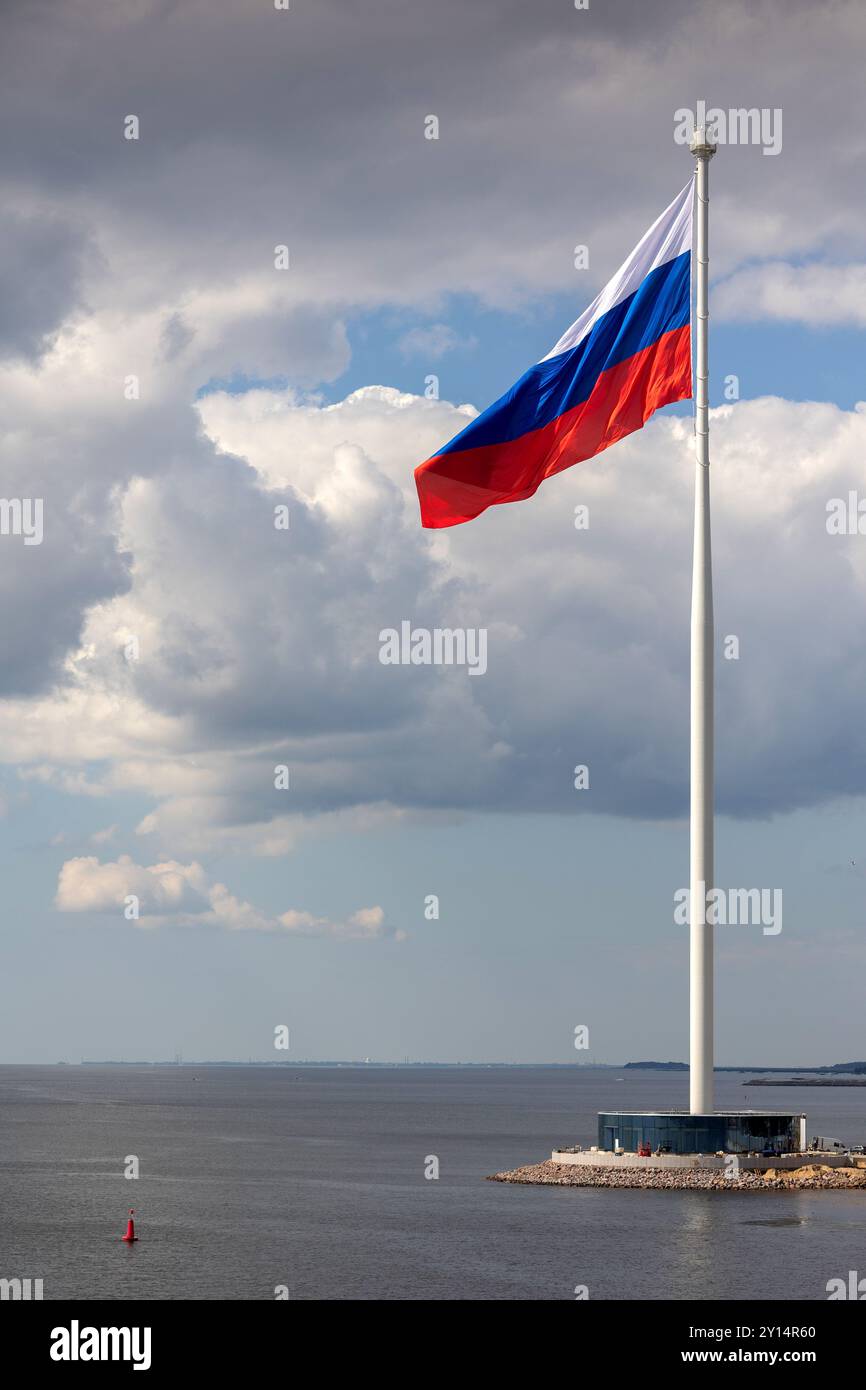 Flag of Russian Federation is flying in air on blue sky and white ...