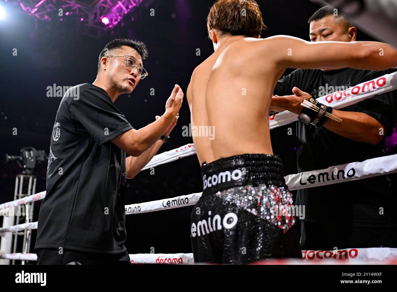 Japanese champion Naoya Inoue, center, listens to his trainer and ...