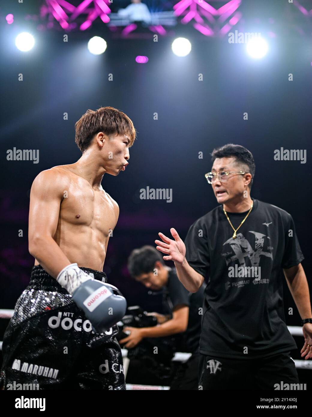 Japanese champion Naoya Inoue, left, listens to his trainer and father ...