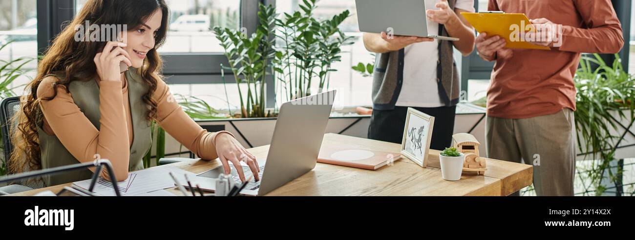 Three colleagues engage in work process in office Stock Photo - Alamy