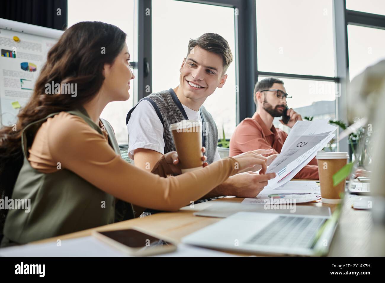 Colleagues share a light moment in office Stock Photo - Alamy