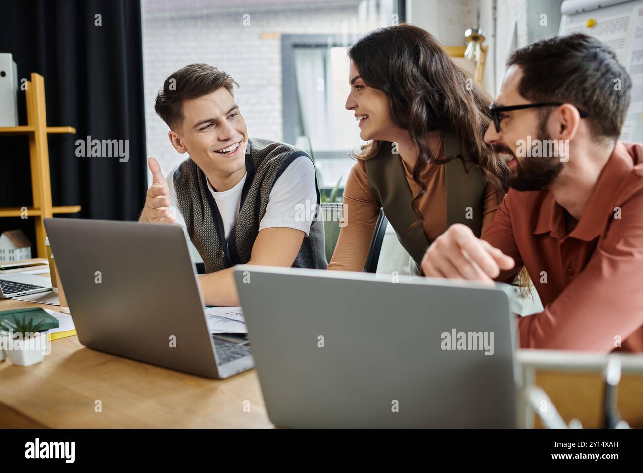 Professionals engage in a supportive conversation in office Stock Photo ...