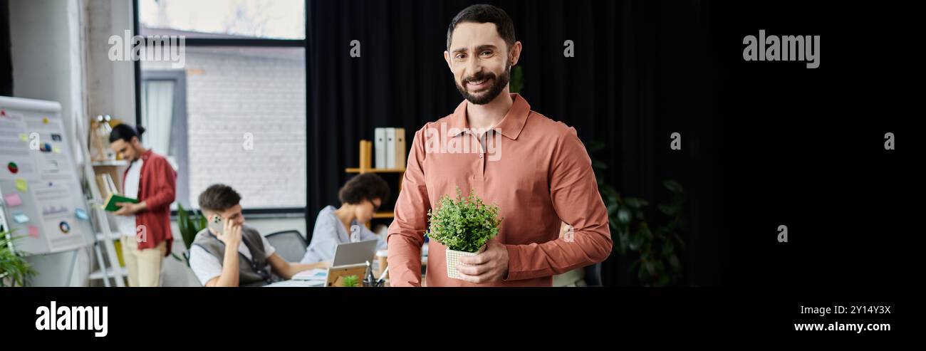 Professional man packing his belongings during lay off in modern office ...