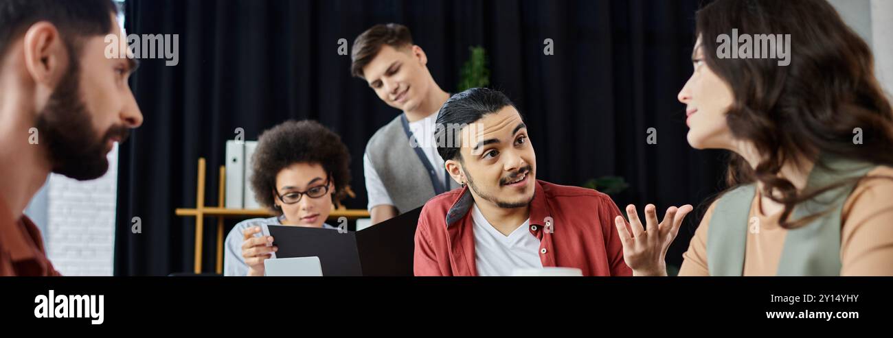 Professionals in elegant attire converse at work Stock Photo - Alamy