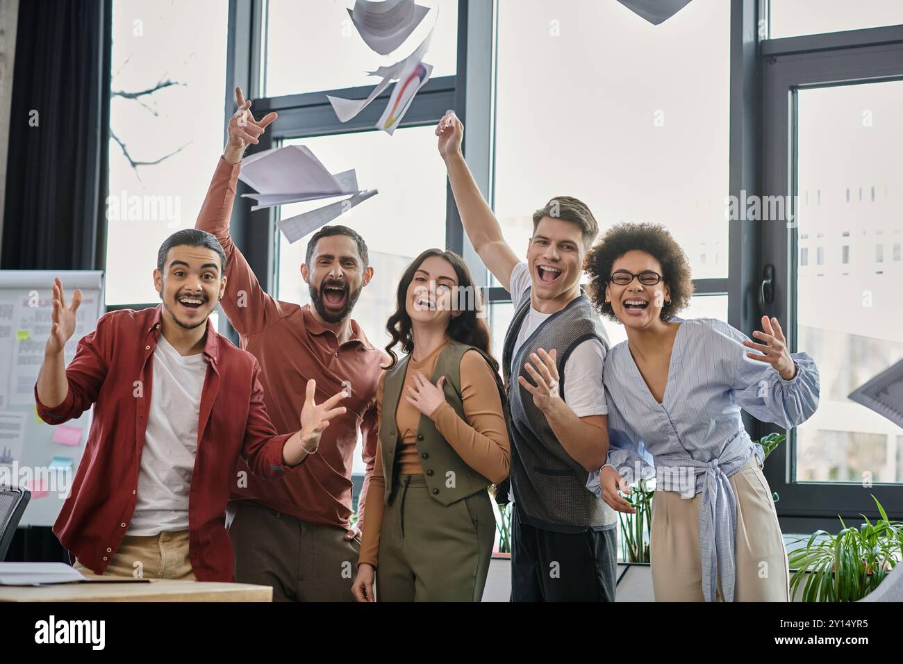 Team members joyfully embrace change while expressing hope in a bright ...