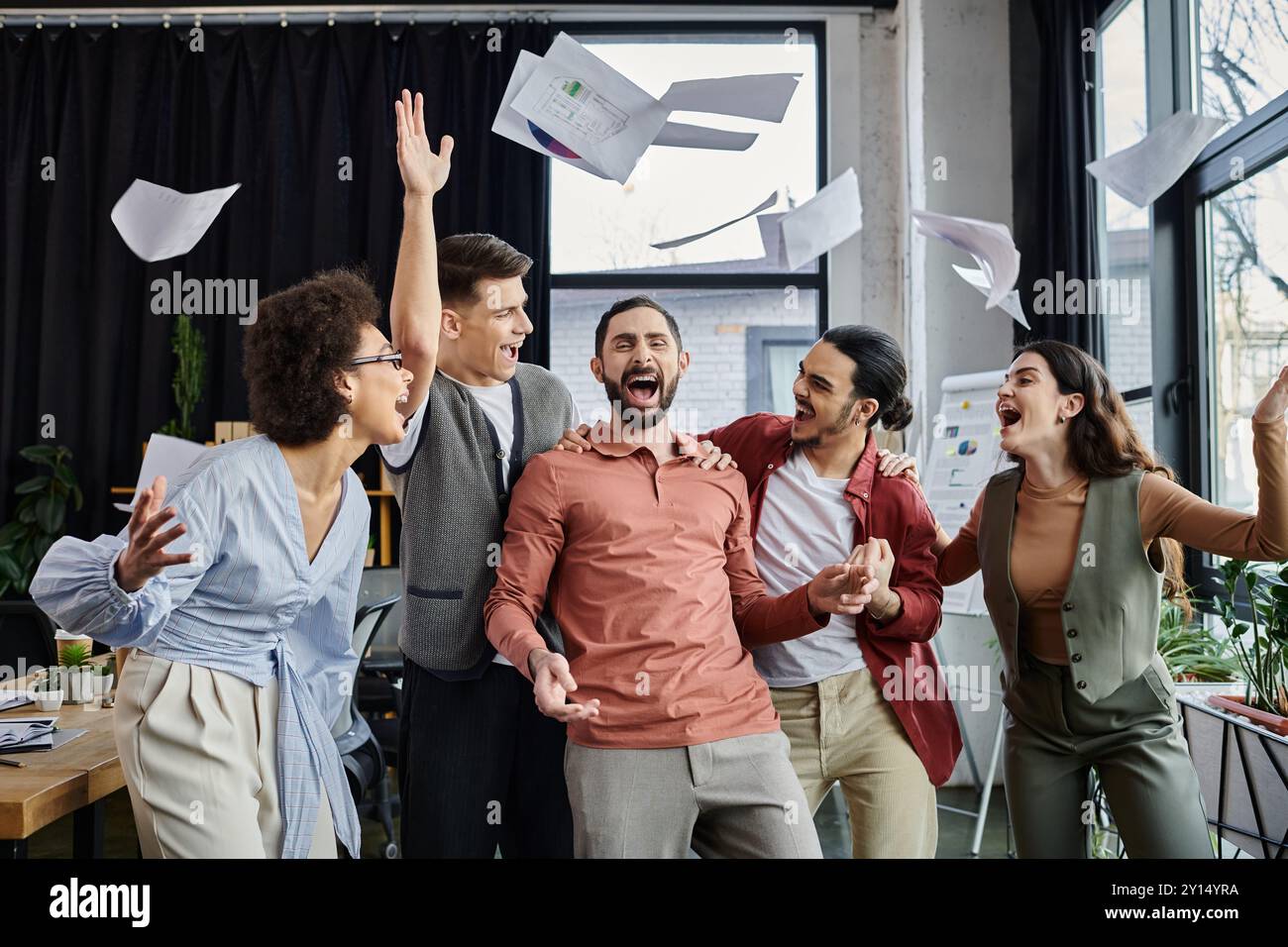 A group of colleagues joyfully celebrate together in office Stock Photo ...