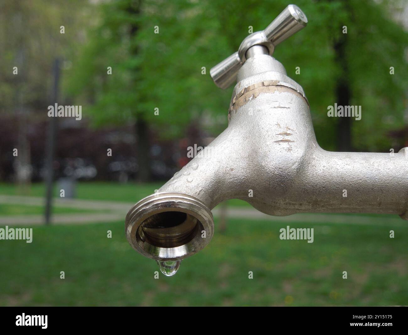 drinking water tap in public park with a water drop on the edge of ...