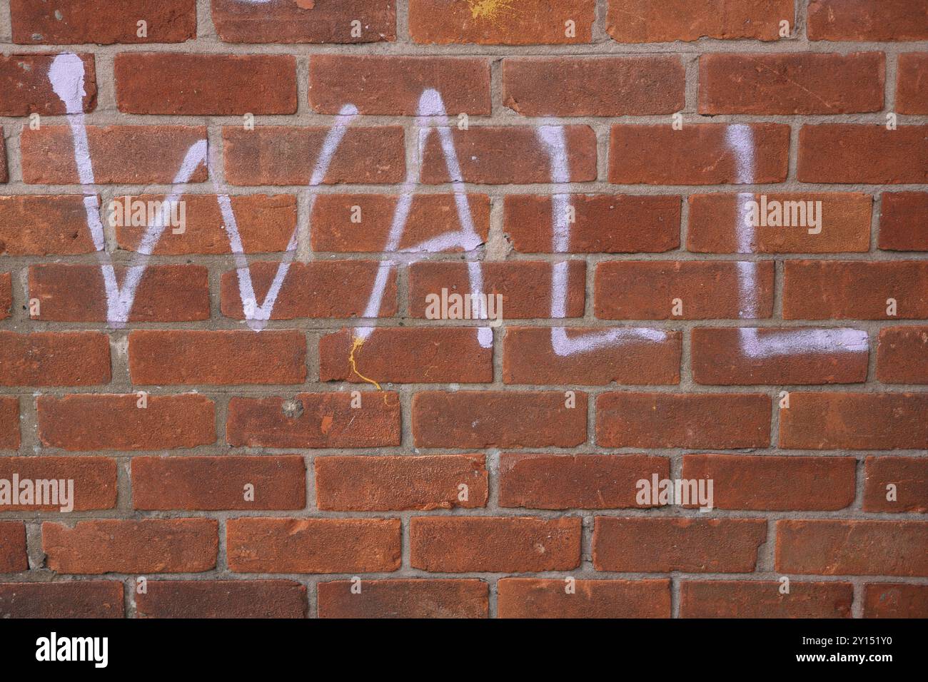 Brick wall with graffiti the word wall in white paint concept wall ...
