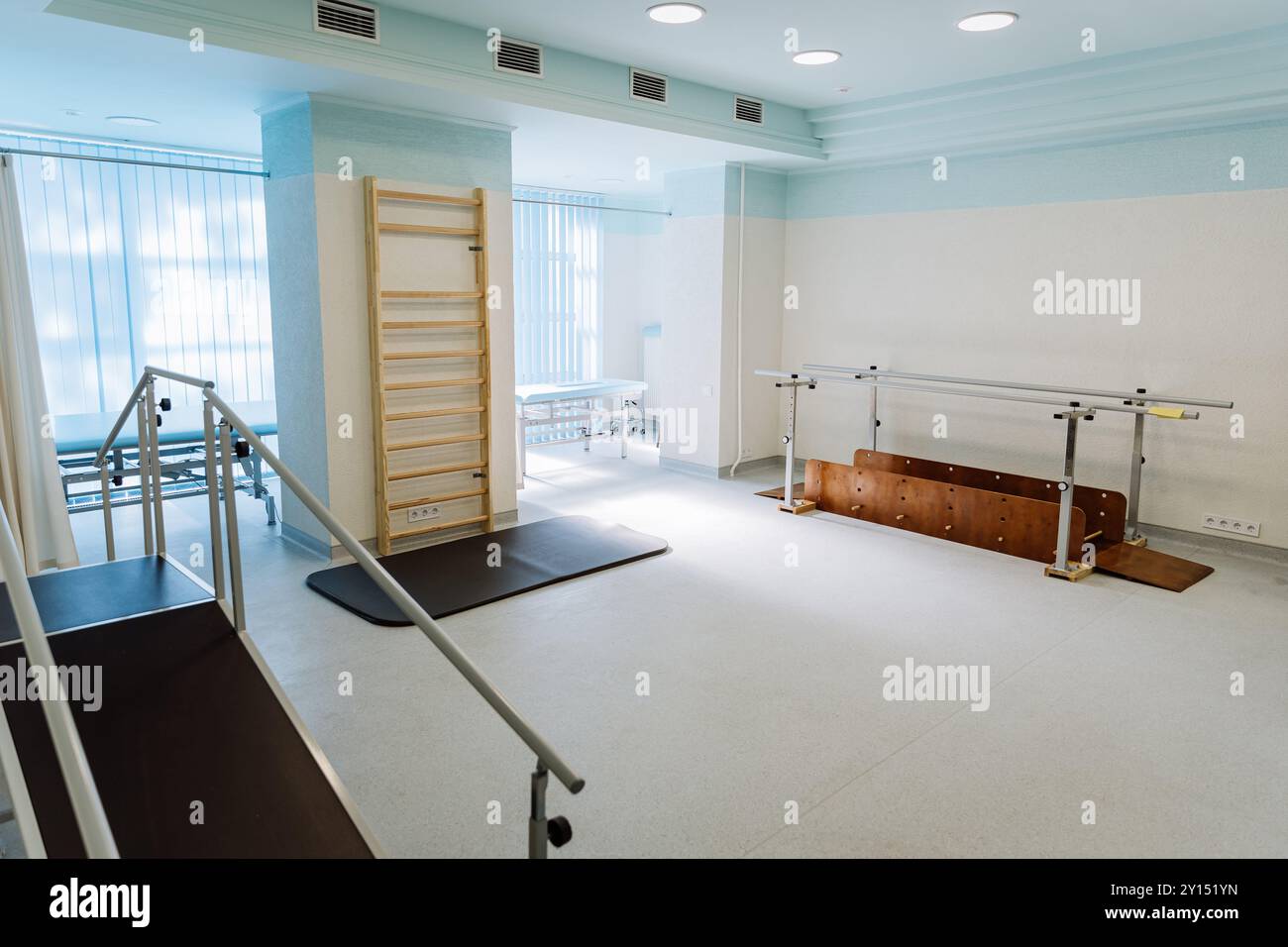 Rehabilitation room with parallel bars and equipment for physical ...