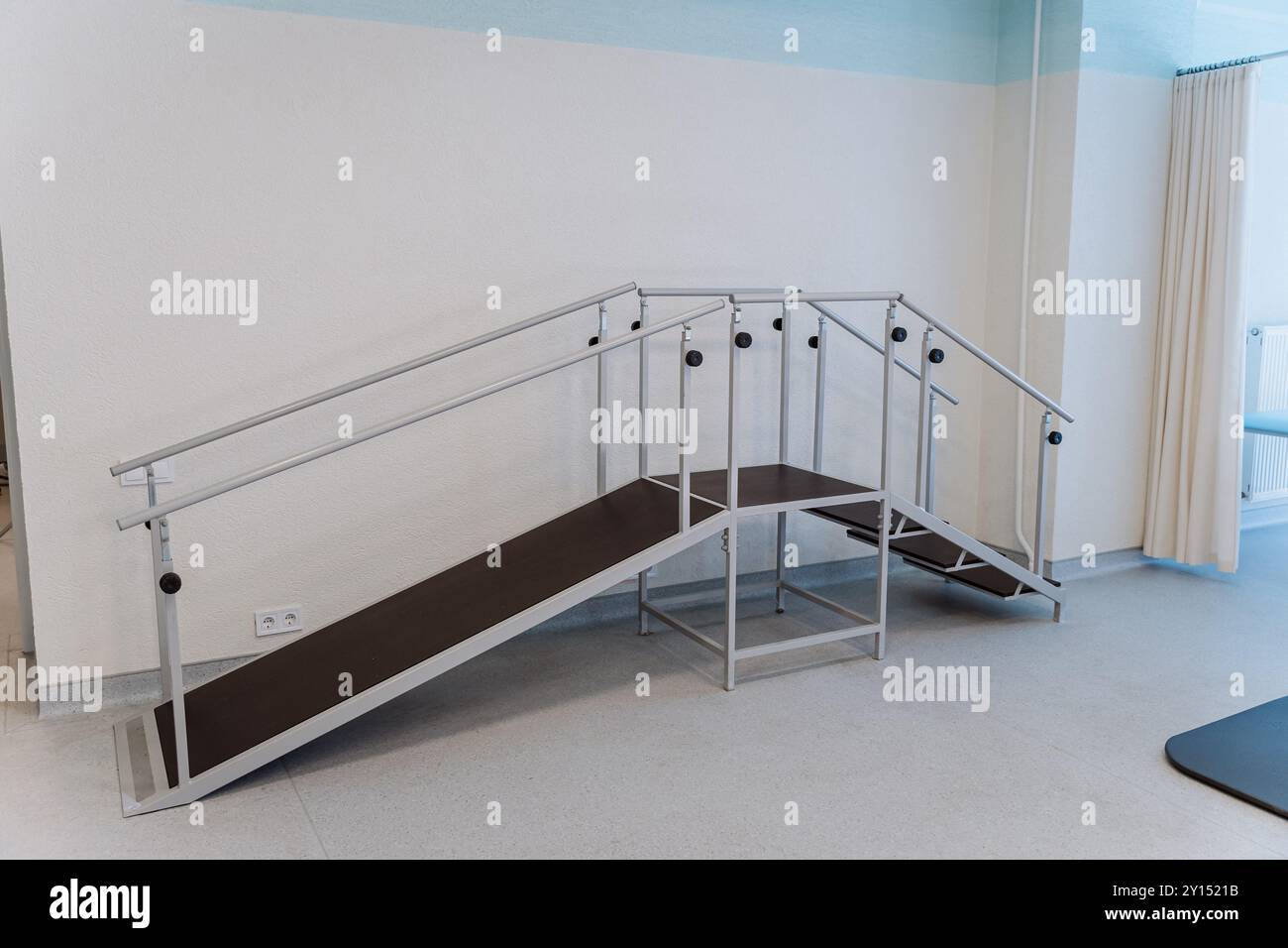 Rehabilitation room with parallel bars and equipment for physical ...