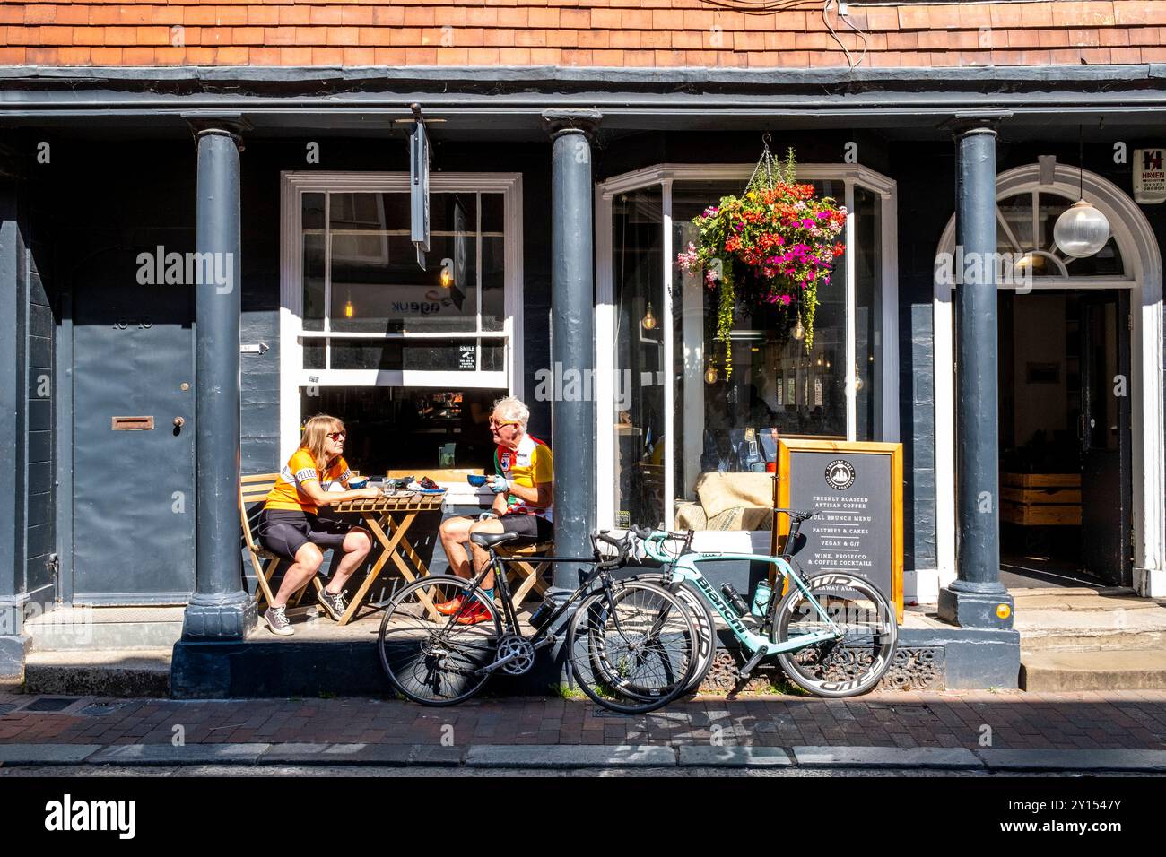 Two Senior Cyclists Sitting Outside A Cafe With A Coffee, High Street ...