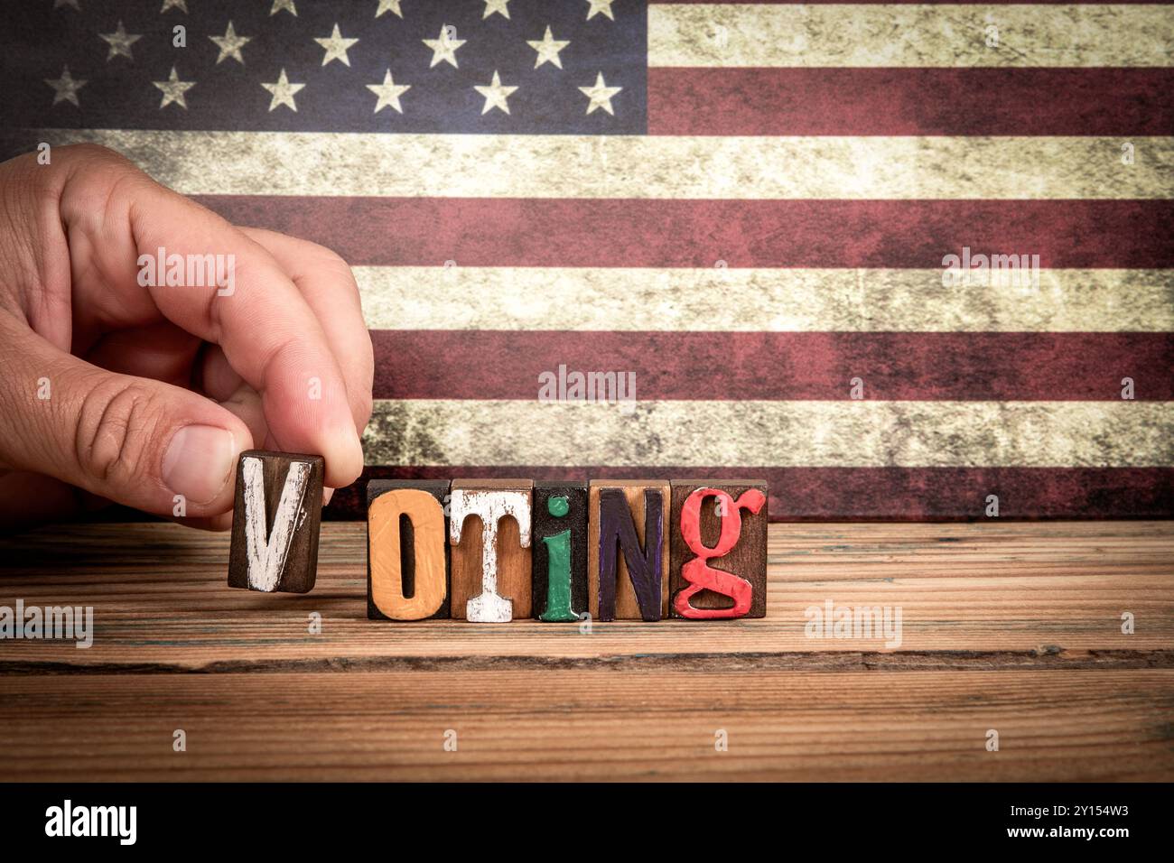 VOTING. Colorful letters of the alphabet on a wooden texture table ...