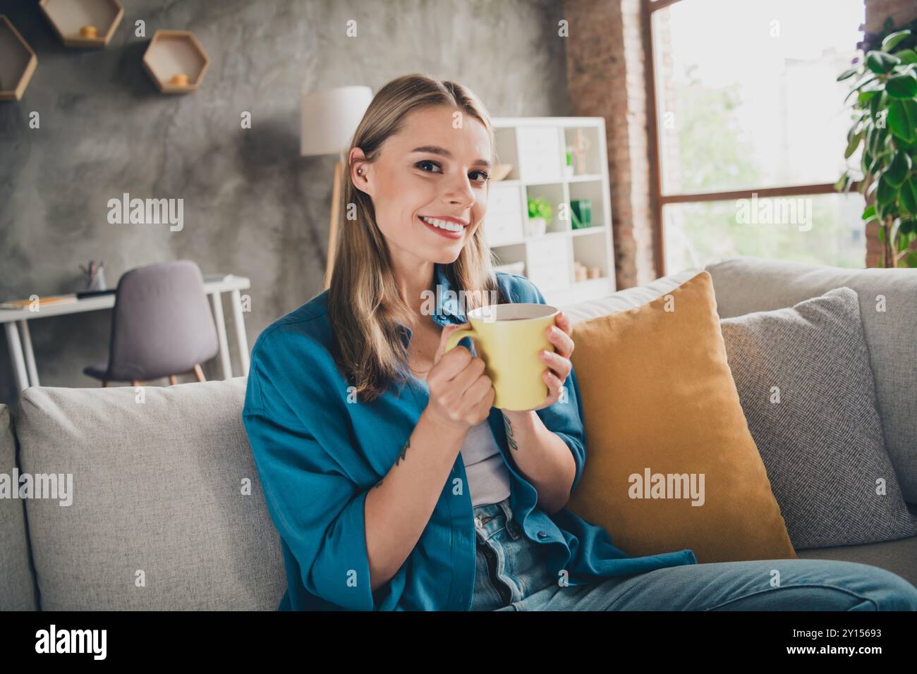 Photo of young cute blonde hair homey woman wearing blue casual shirt ...