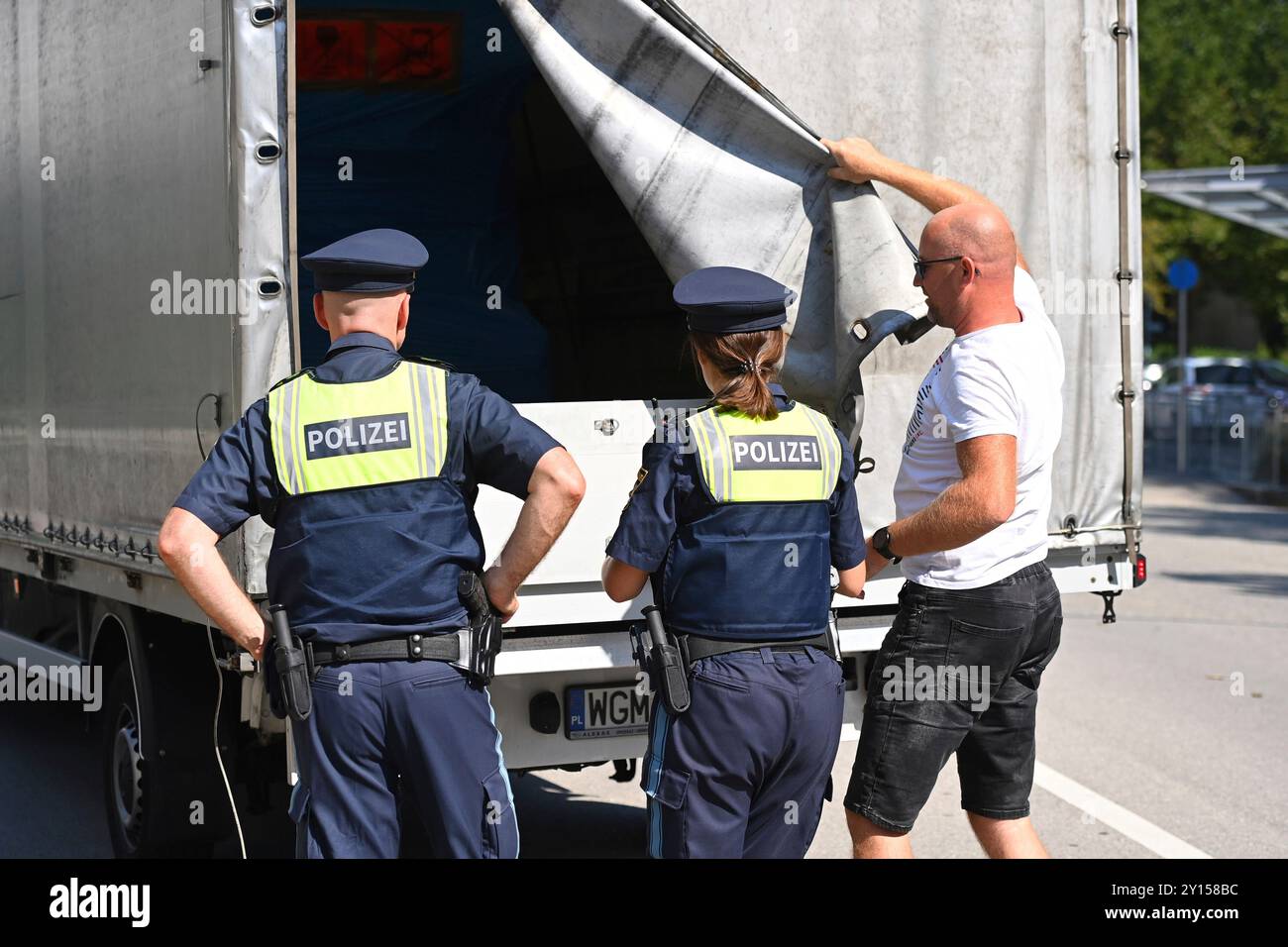 Border police officers have the loading area of a Polish van opened ...