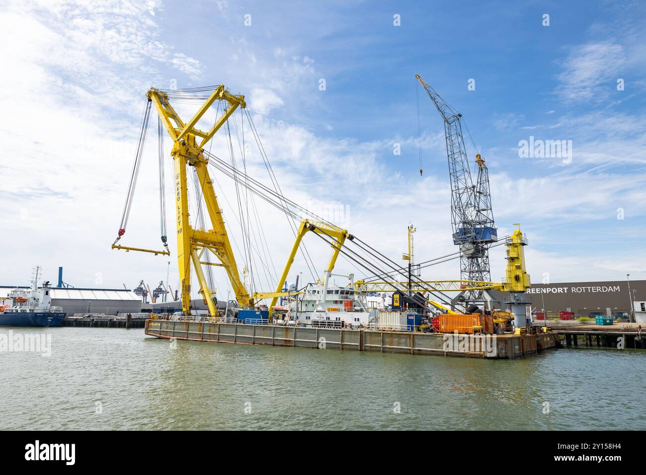 Special crane for lifting heavy loads on a ship in the industrial port ...