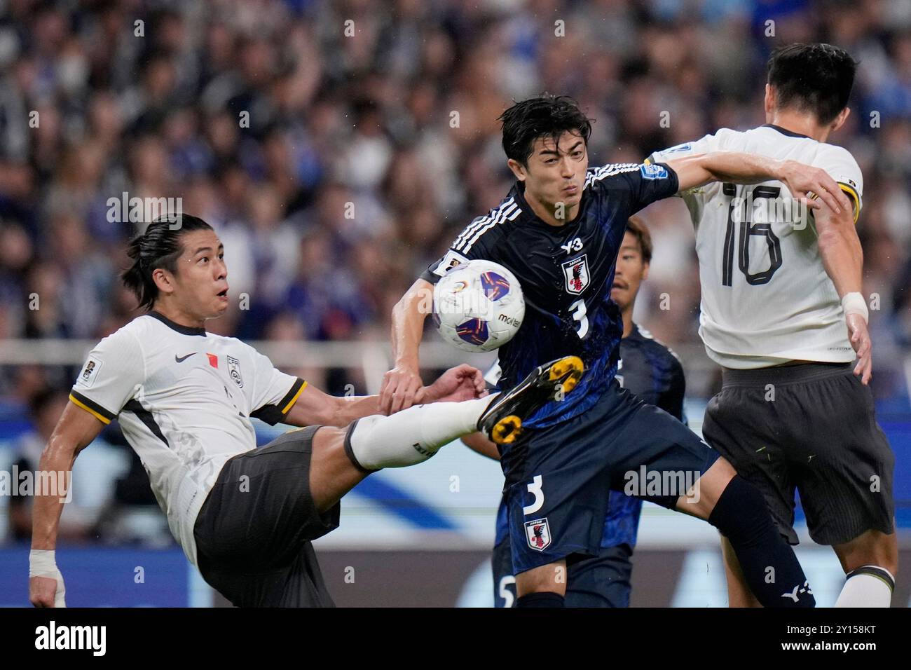 China's Zhang Yuning, and Japan's Shogo Taniguchi, compete for the ball ...