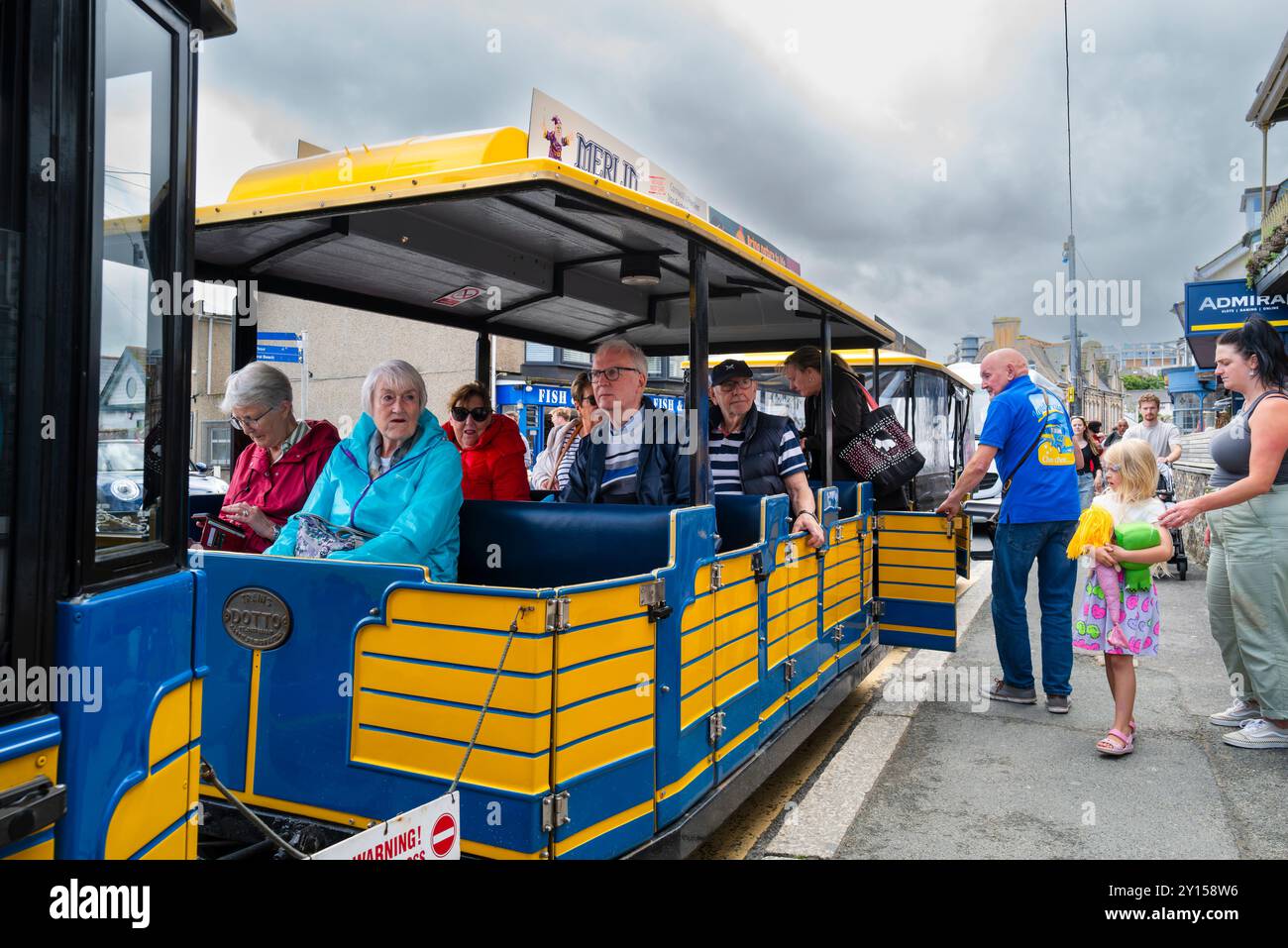 Passengers sitting on the colourful colorful Newquay Road Train parked ...