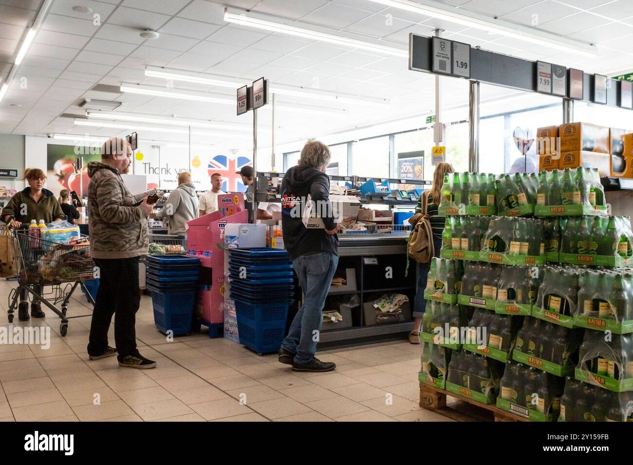 Shoppers people customers at the checkout paying for goods inside a ...