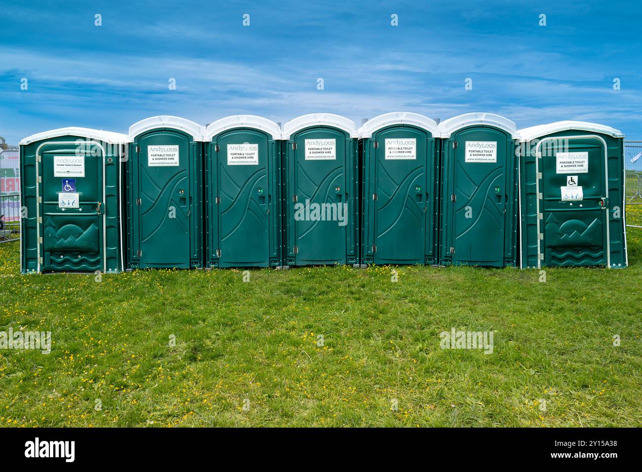 A row of portable toilets at an outdoor event in Newquay in Cornwall in ...