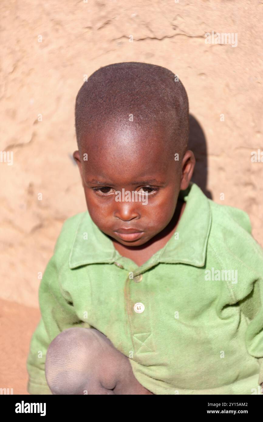 hungry village African child standing in the yard Stock Photo - Alamy