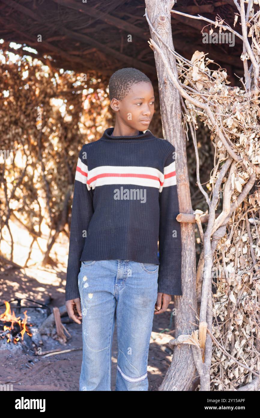 hungry village African child standing in the yard Stock Photo - Alamy