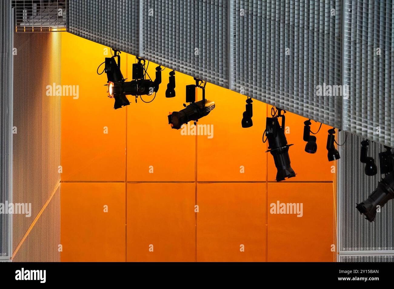 Ceiling-mounted stage lights and equipment silhouetted against a ...