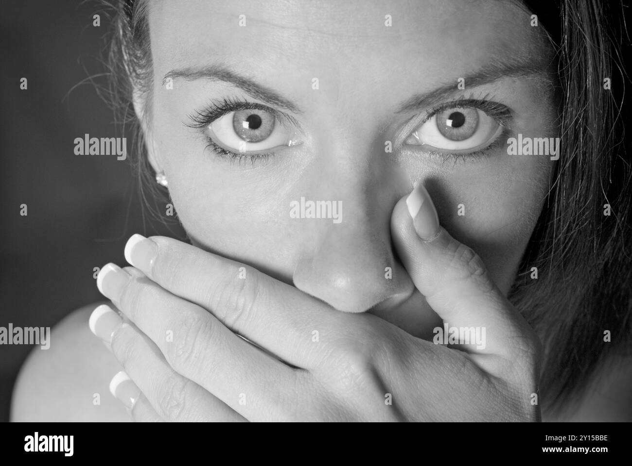 Woman hand over mouth thoughtful hi-res stock photography and images ...