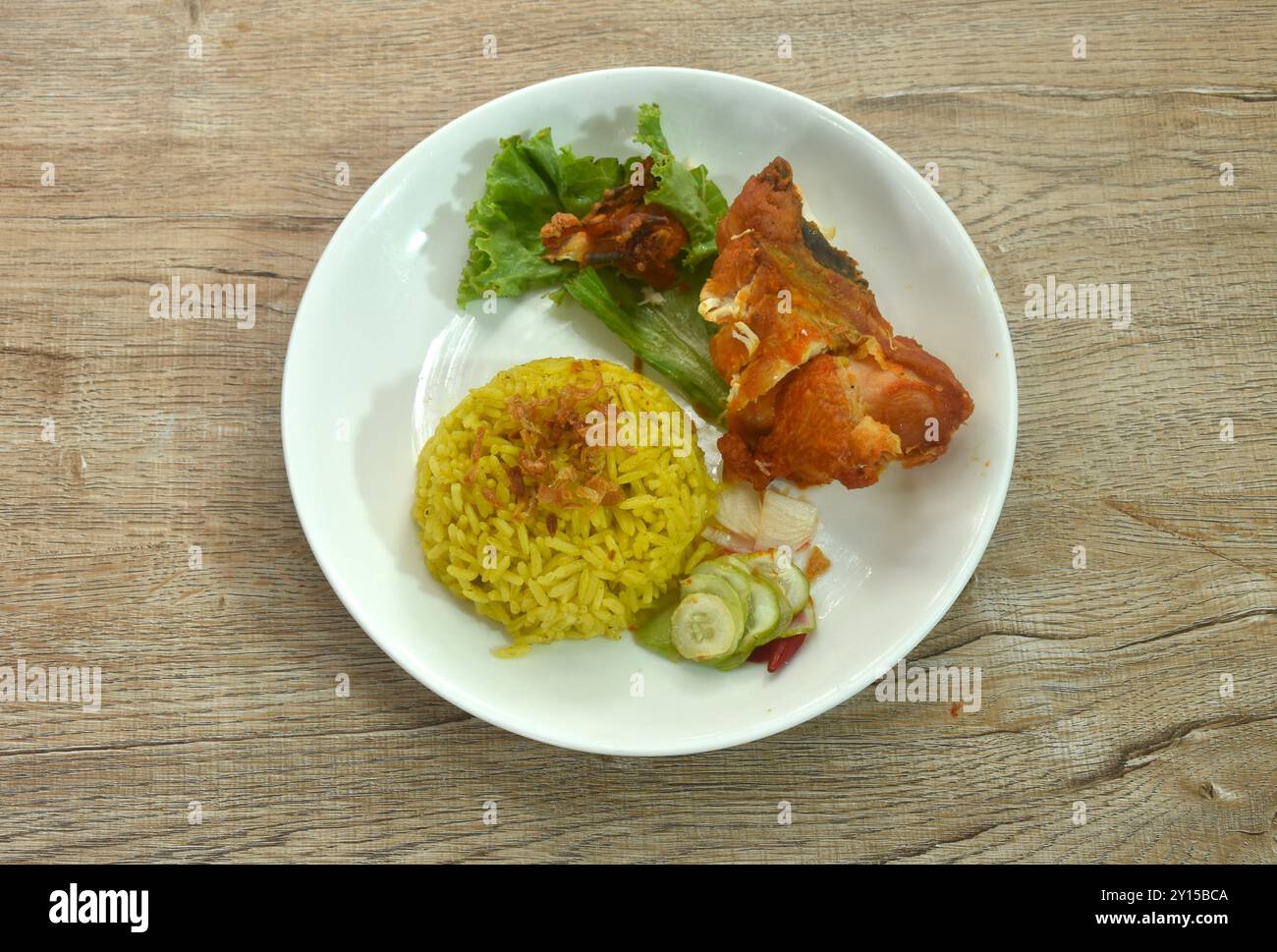 chop fried chicken and biryani rice cooked with curry on plate dipping ...
