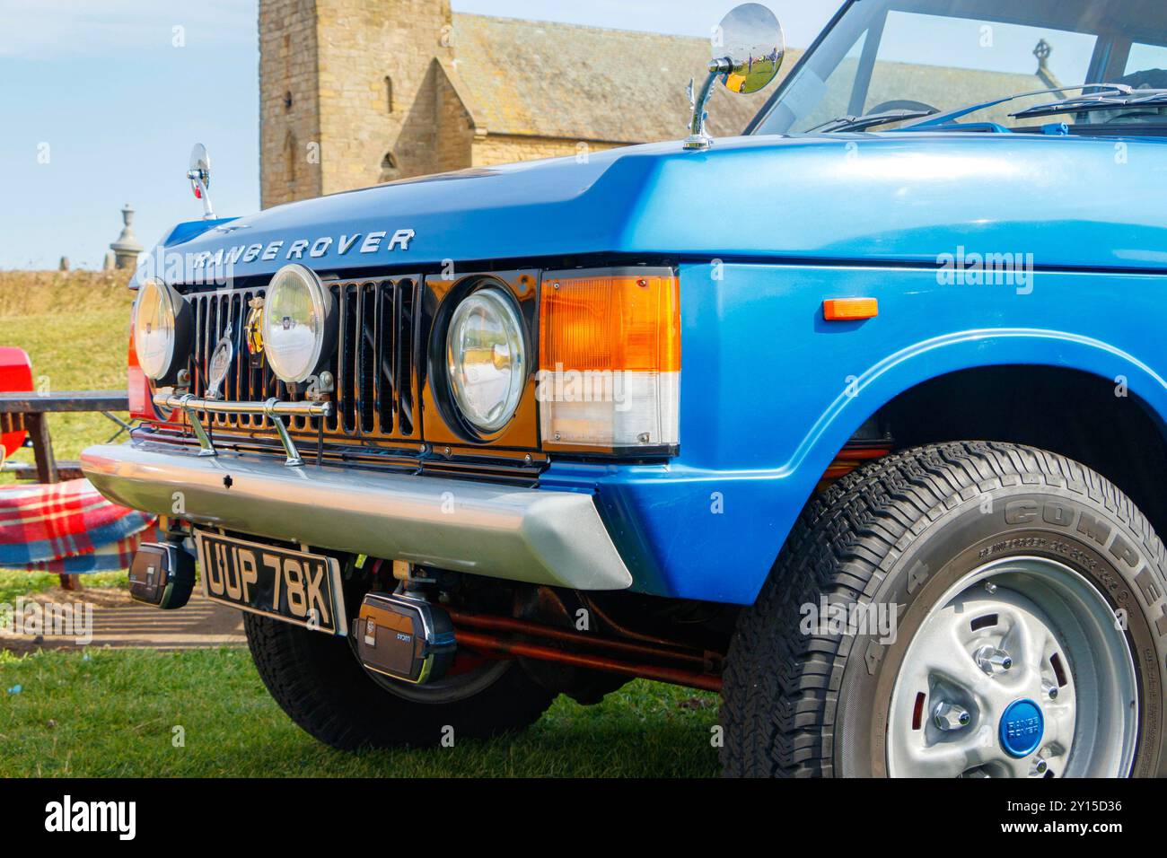 Close-up view of a classic blue Range Rover parked on a grassy field ...