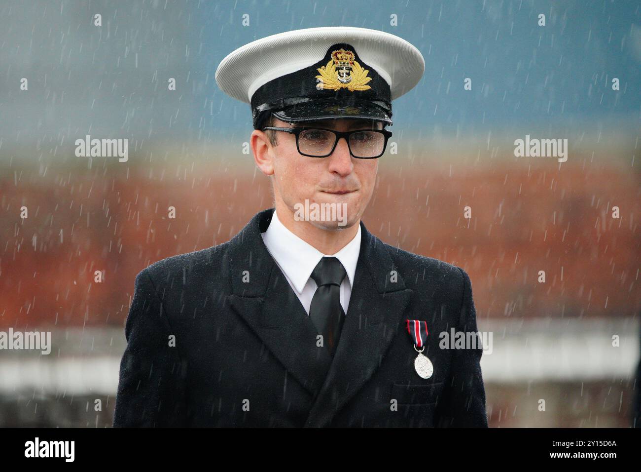 Members of the Royal Navy from HMS Diamond stand on parade in the rain ...
