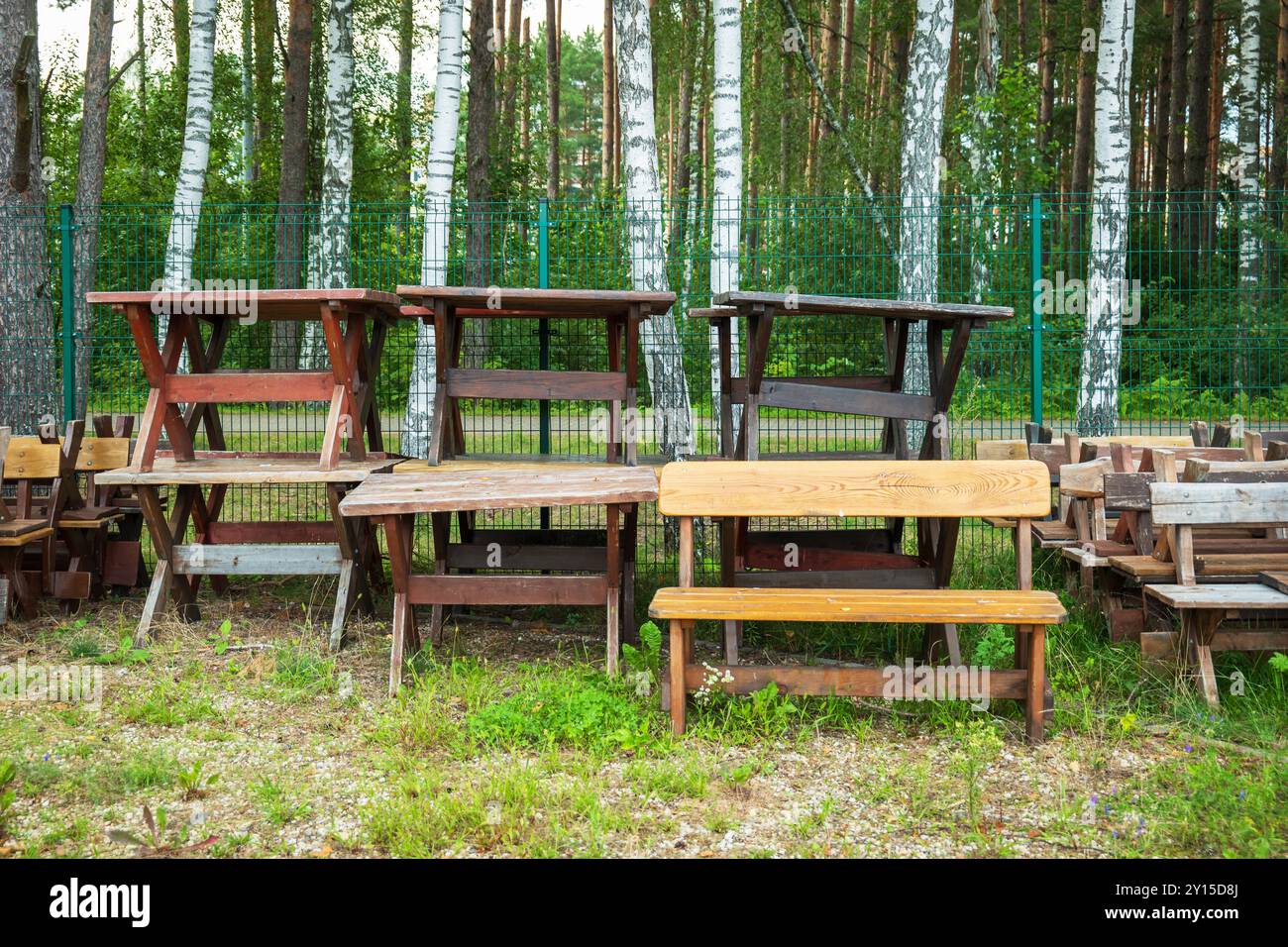 Wooden garden tables and benches stacked in backyard Stock Photo - Alamy