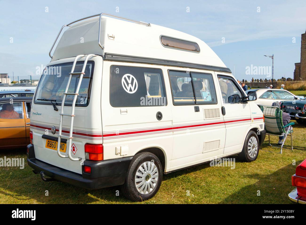 A classic white high top Volkswagen Transporter T4 camper van parked on ...