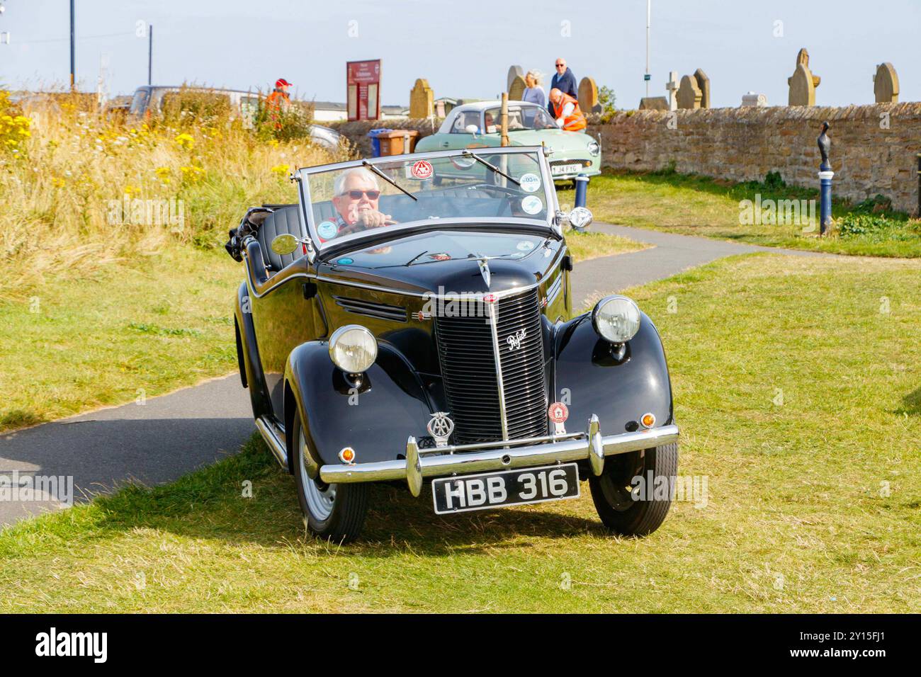 A classic black vintage convertible ford prefect car with the license ...
