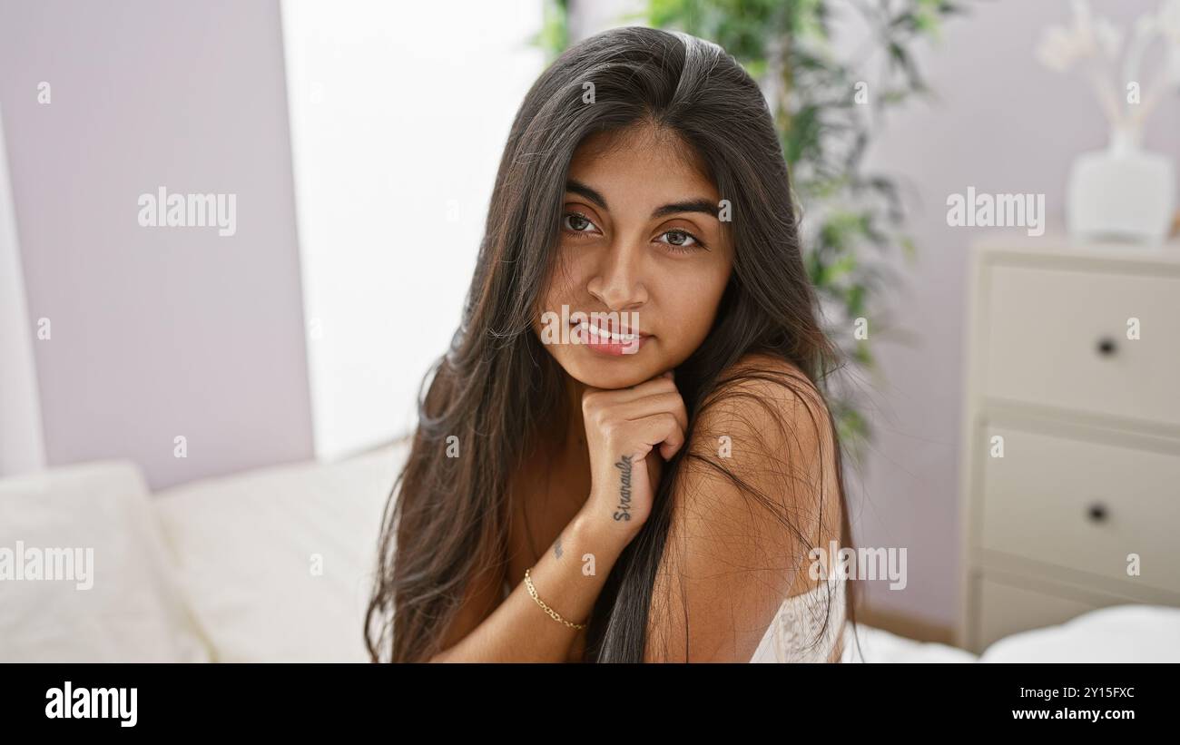 A beautiful young south asian woman with long hair poses casually in a ...