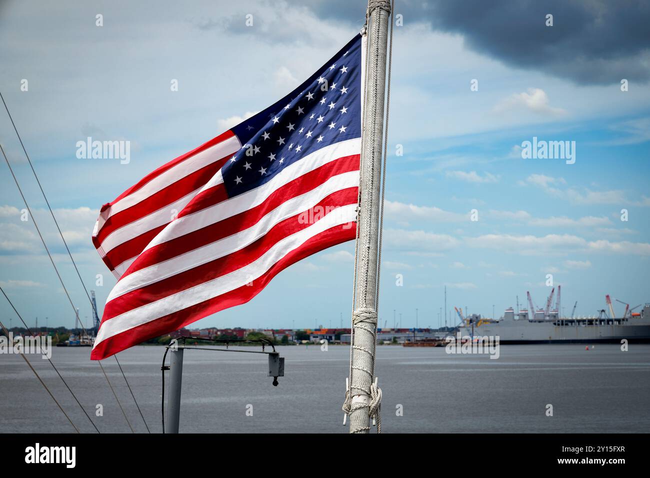 The wind blows an American flag on the stern of the USS Wisconsin (BB ...