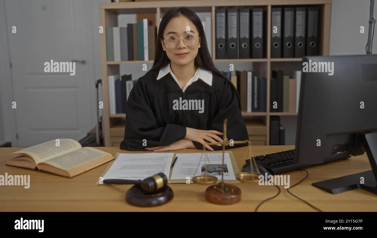 Female judge in an office wearing glasses and judicial robe with legal ...