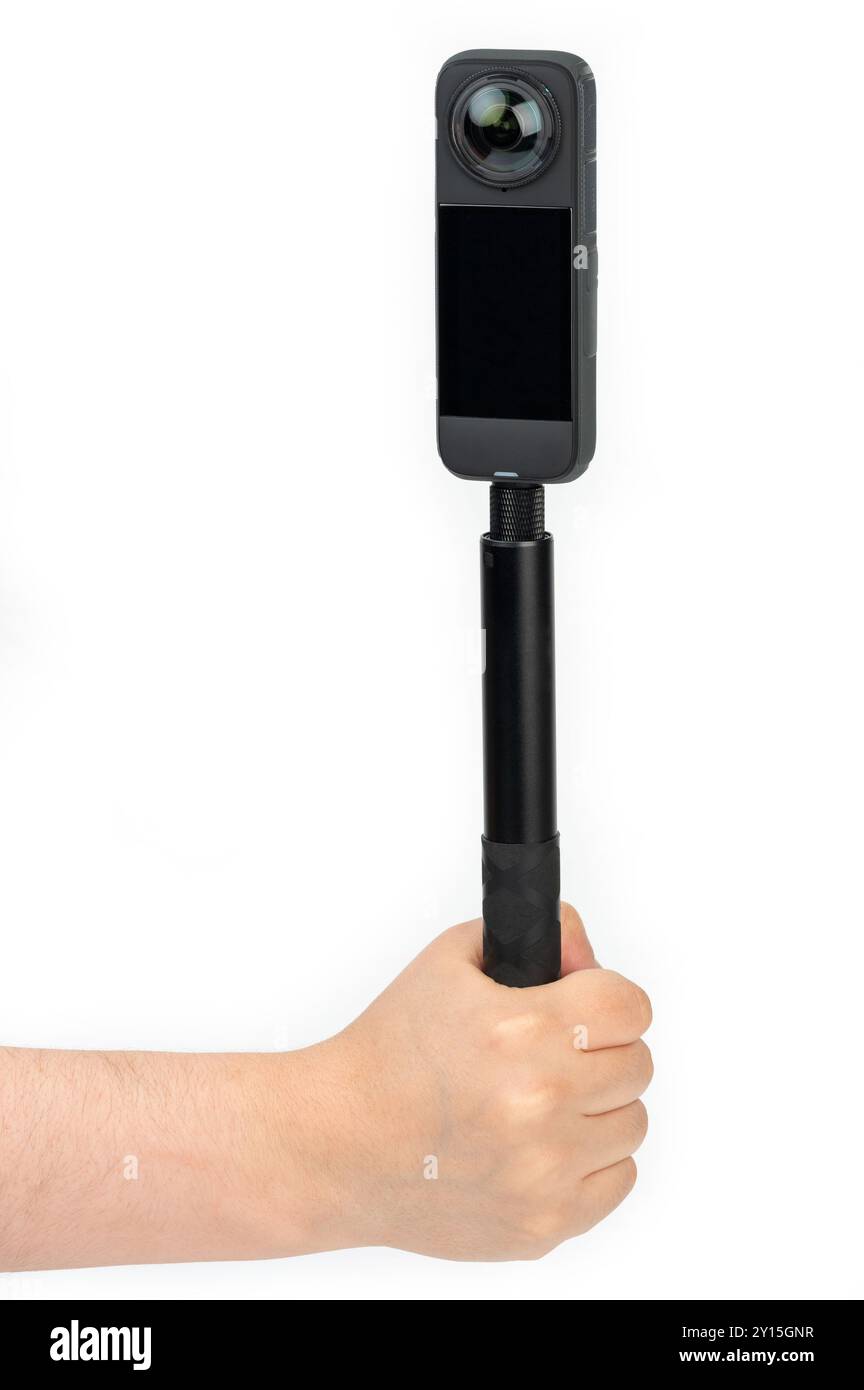 Action camera on selfie stick in hand isolated on white studio ...