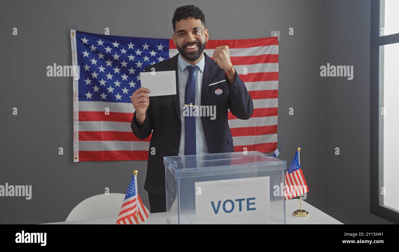 A smiling young hispanic man with a beard proudly showing an envelope ...
