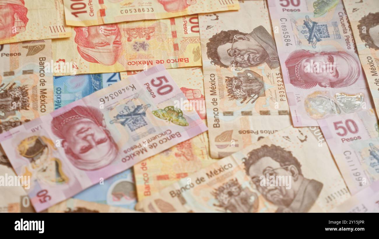 Mexican banknotes in various denominations scattered, showcasing ...