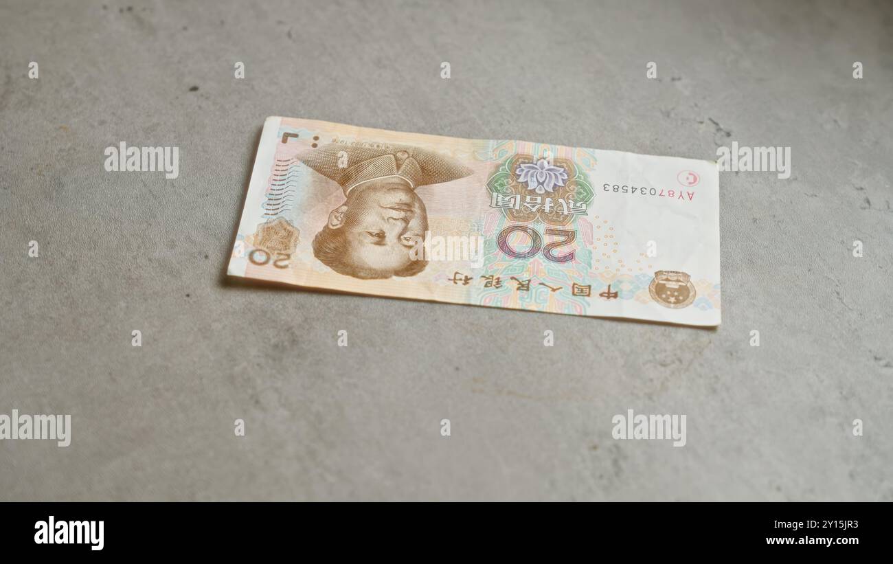 Chinese yuan banknote on a concrete surface representing financial ...