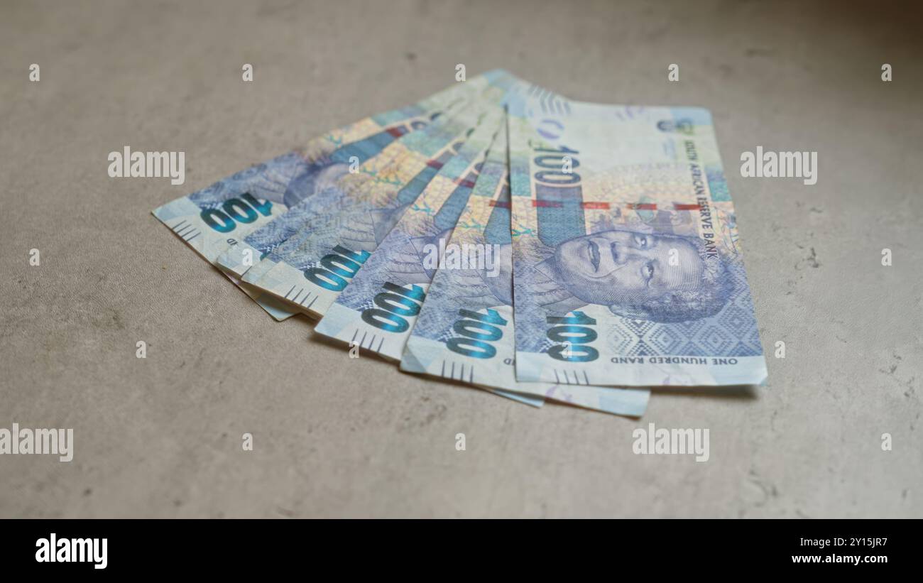South african 100 rand banknotes featuring mandela are spread out on a ...