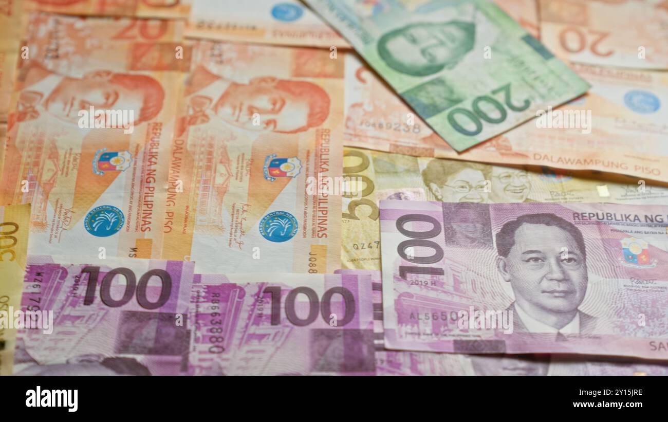 Philippine banknotes scattered, displaying various denominations and ...